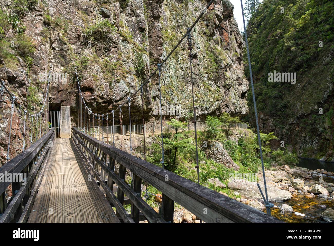 The walking path on the hanging bridge crossing the river at the gorge ...