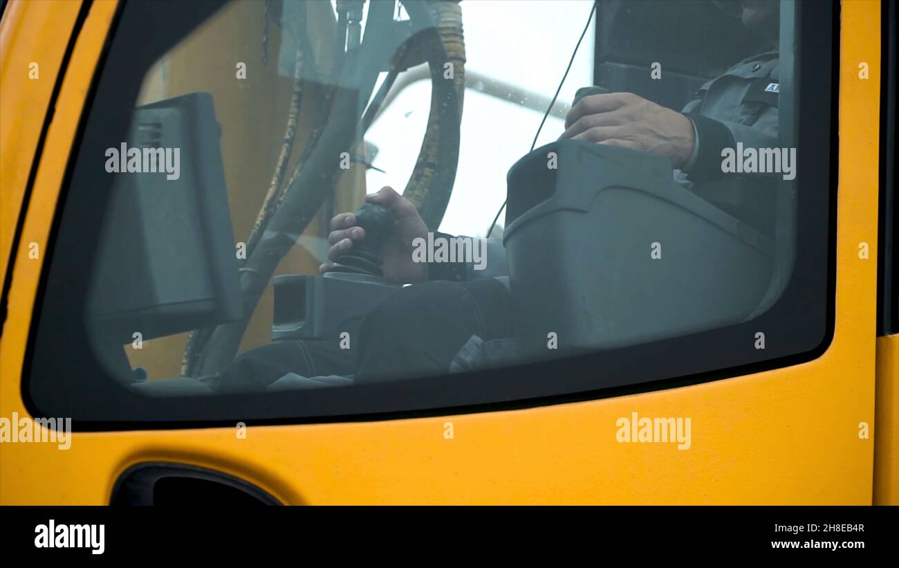 Drivers cab of a yellow crane working on a construction site. Clip ...