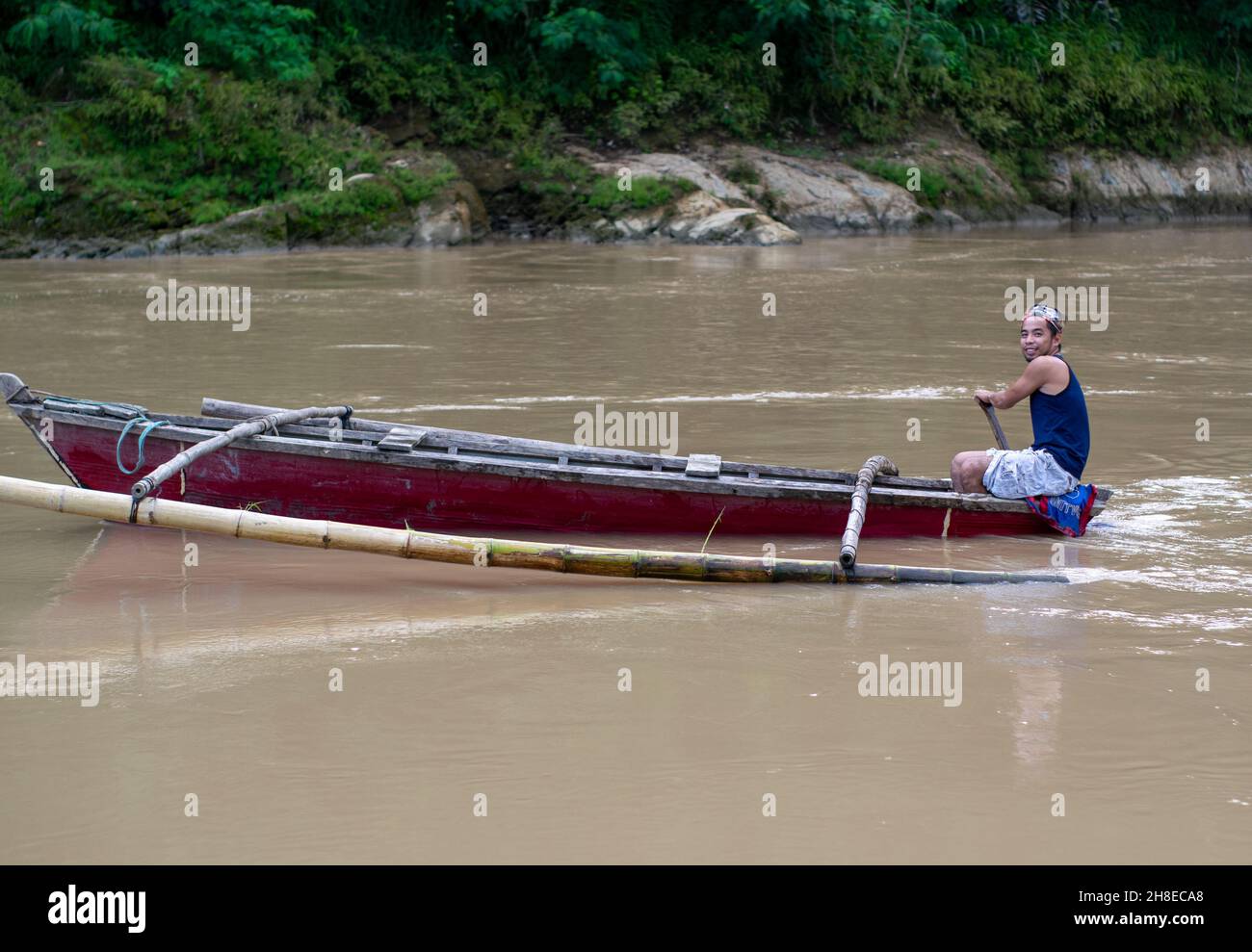DAVAO CITY, PHILIPPINES - Oct 17, 2021: A young male in a paddle boat ...