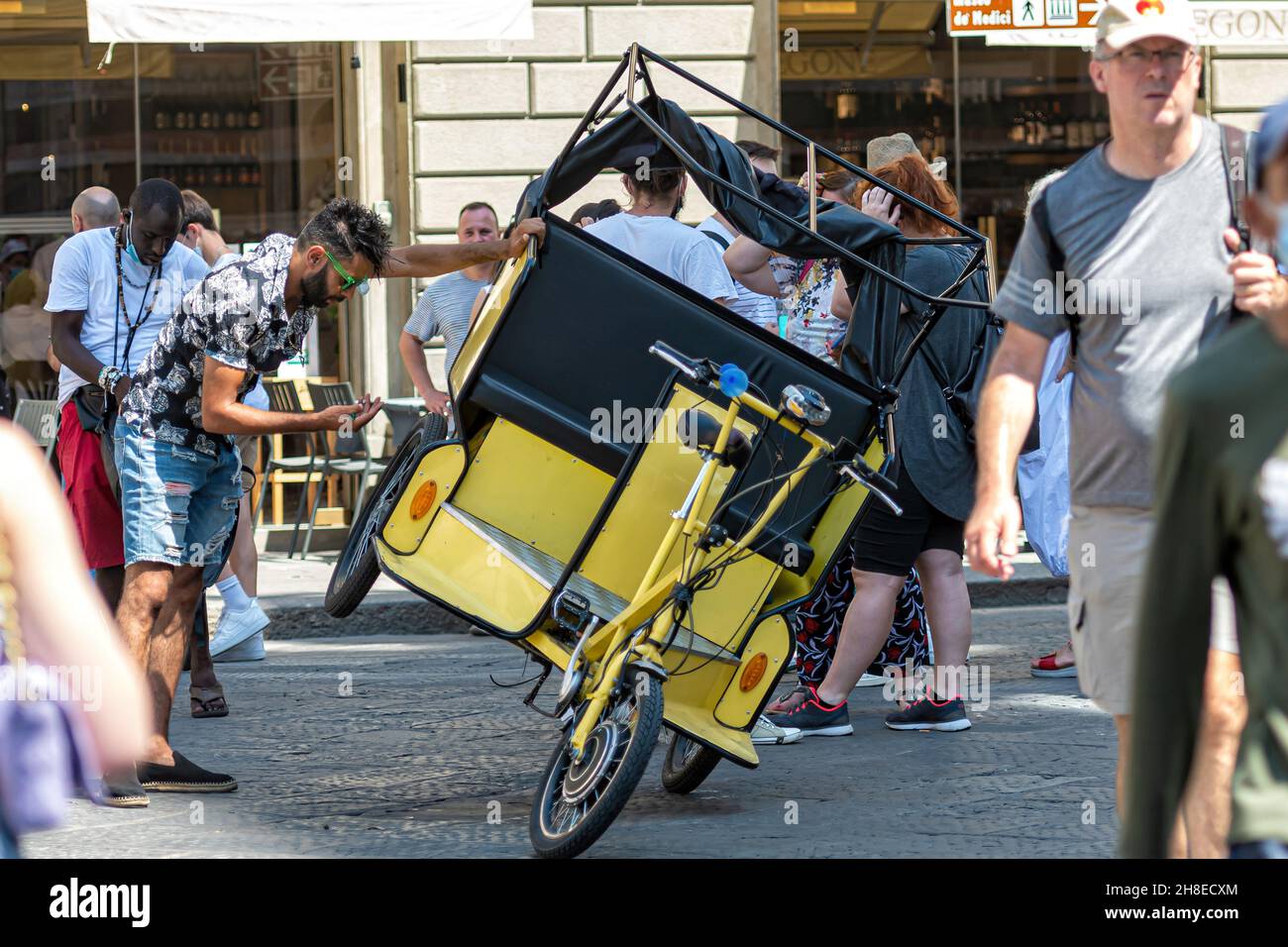 Florence, Italy - August 11, 2021: driver repairs a rickshaw in a ...