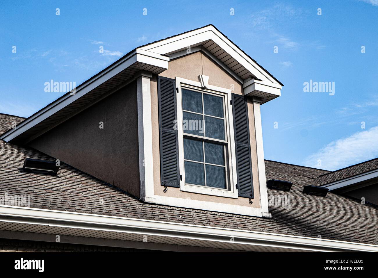 Modern brick architecture black trim side roof window Stock Photo - Alamy
