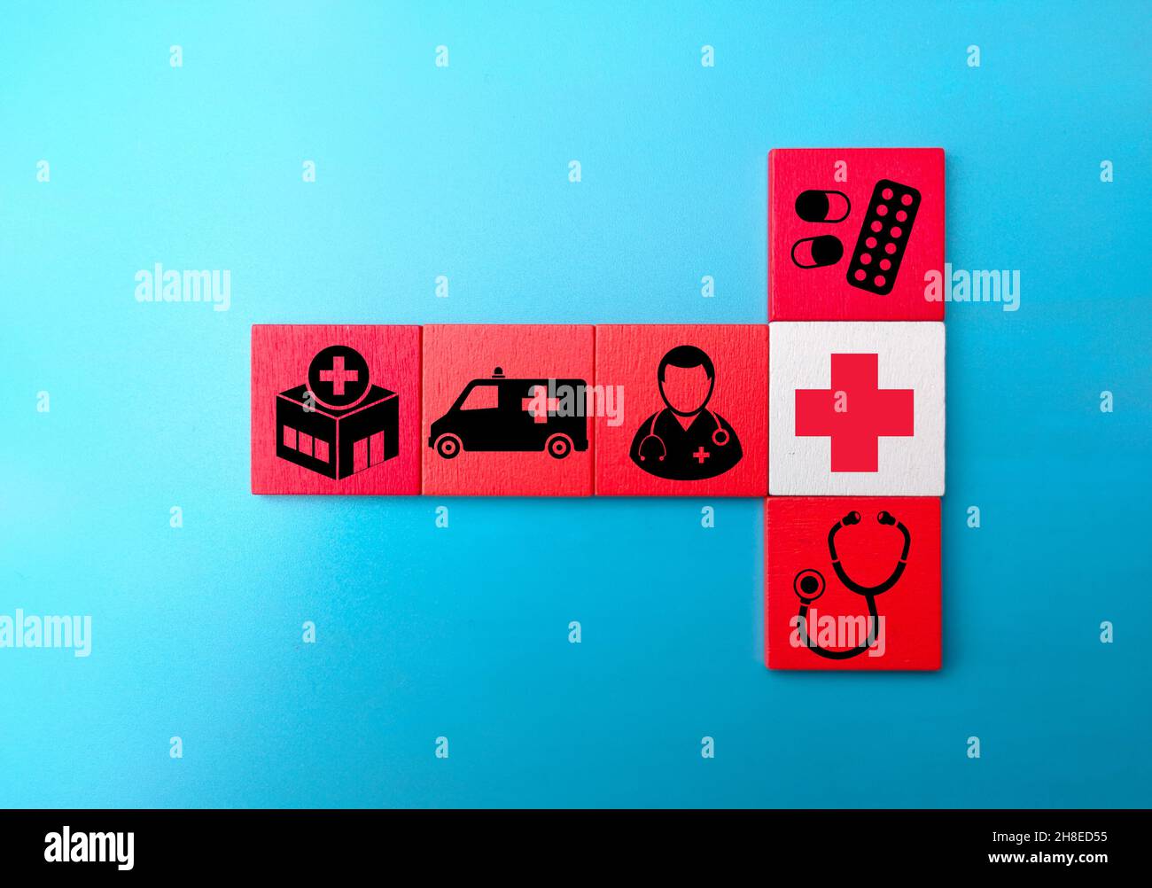 Red wooden squares with medical icons isolated on a blue background ...