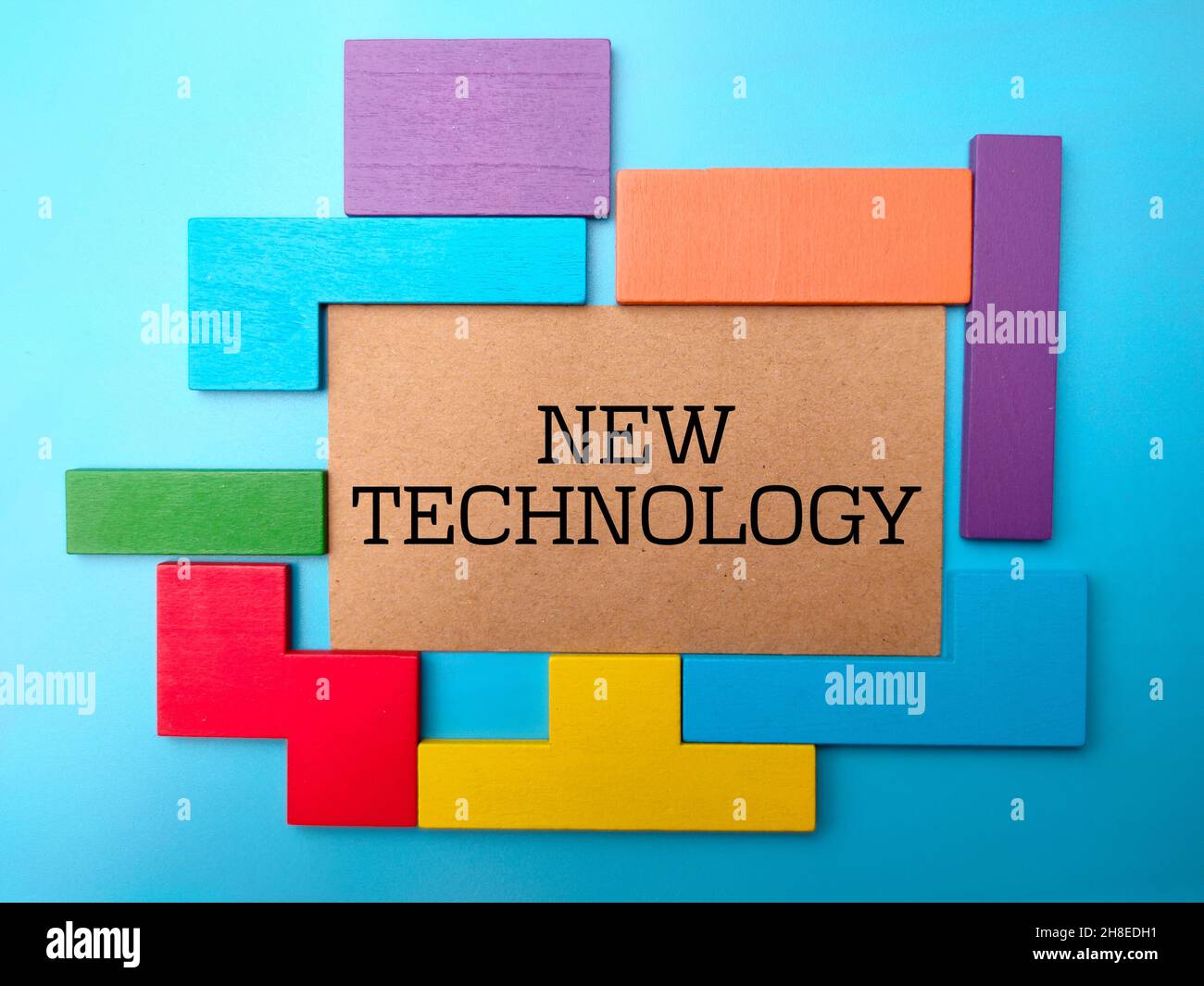 Colorful wooden block puzzle and a brown card with the "New Technology ...