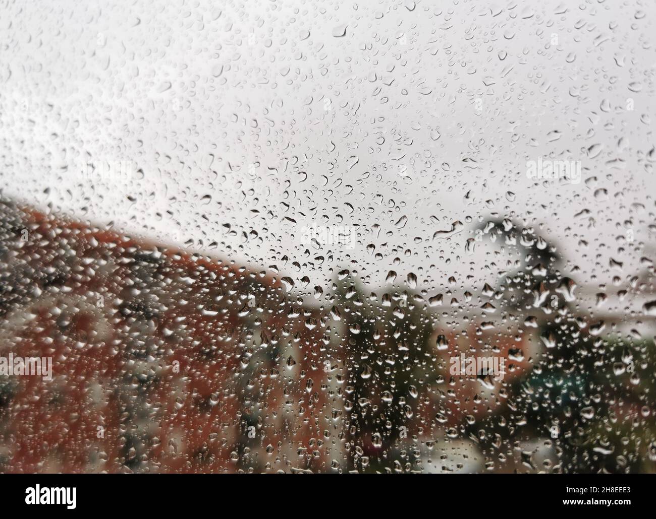 Glass window with many raindrops on it Stock Photo - Alamy
