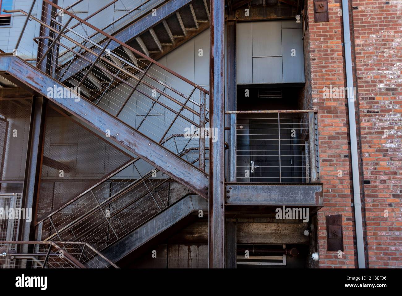 Low angle view of a fire escape outside of a brick building in downtown ...