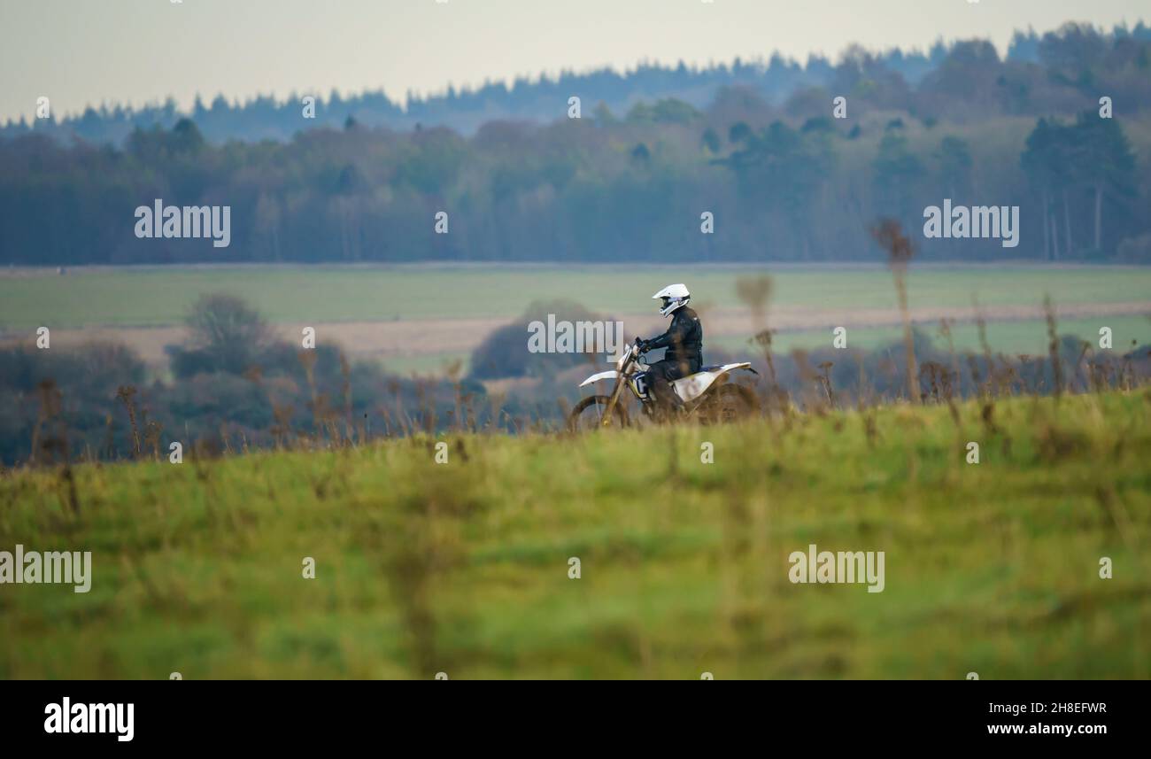 side profile of a motor cyclist (biker) riding his off-road motorbike ...