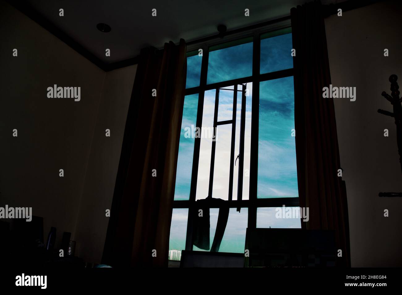 Blue sky from a window of a dark room Stock Photo - Alamy