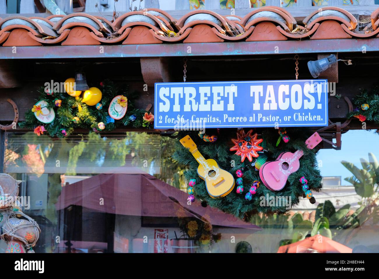 A sign advertising Street Tacos made with Carnitas, pork al pastor, and ...