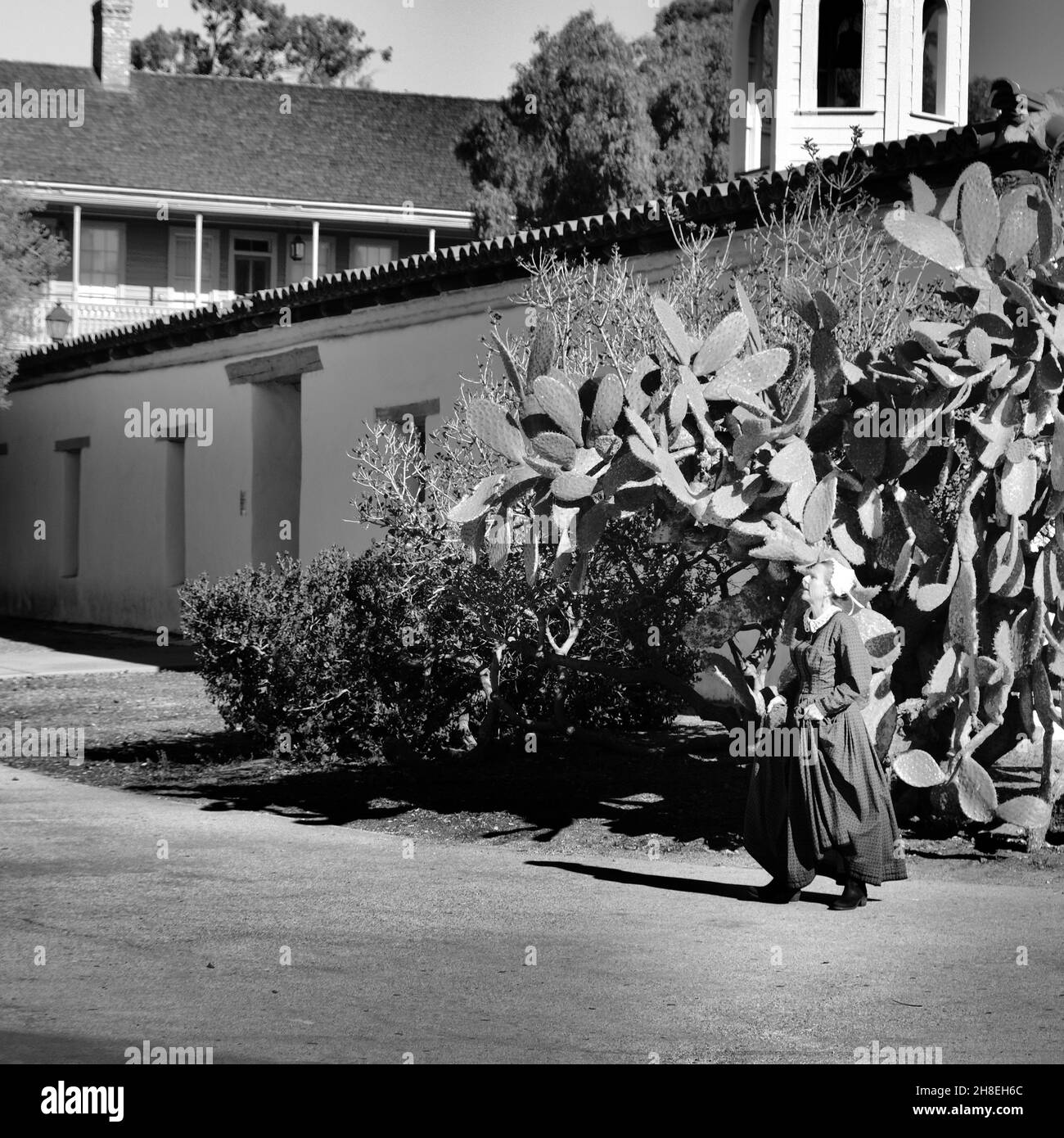 A woman in a pioneer period dress walking in Old Town, San Diego ...