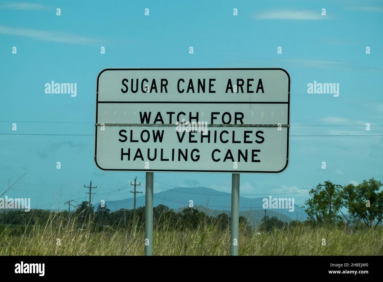 Road sign warning of sugar cane area and watch for slow vehicles ...