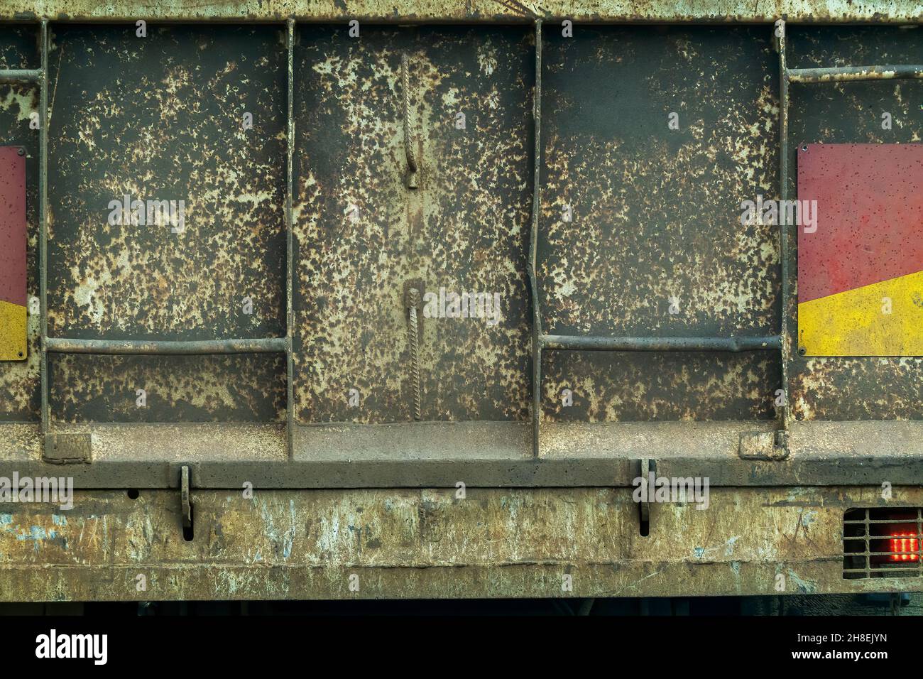 The texture of the rusting back of a semi trailer truck hauling freight ...