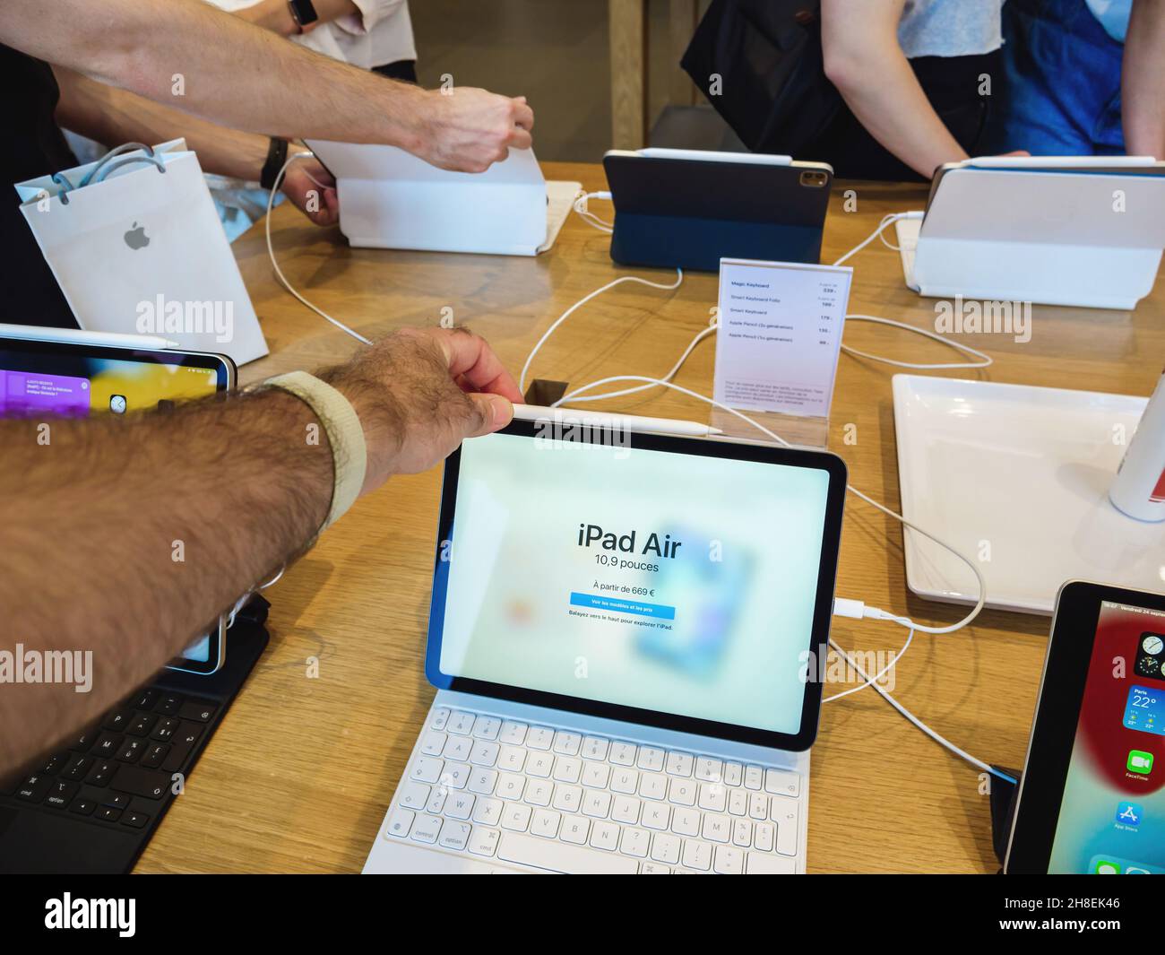ipad Air in Apple Store with multiple hands of customers and Genius ...