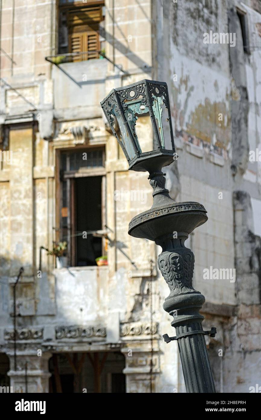 A damaged lamp post leans to oneside in Havana's Chinatown district ...