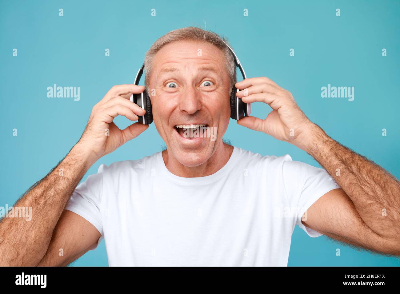 Headshot Portrait Of Excited Mature Man Wearing Wireless Headphones ...