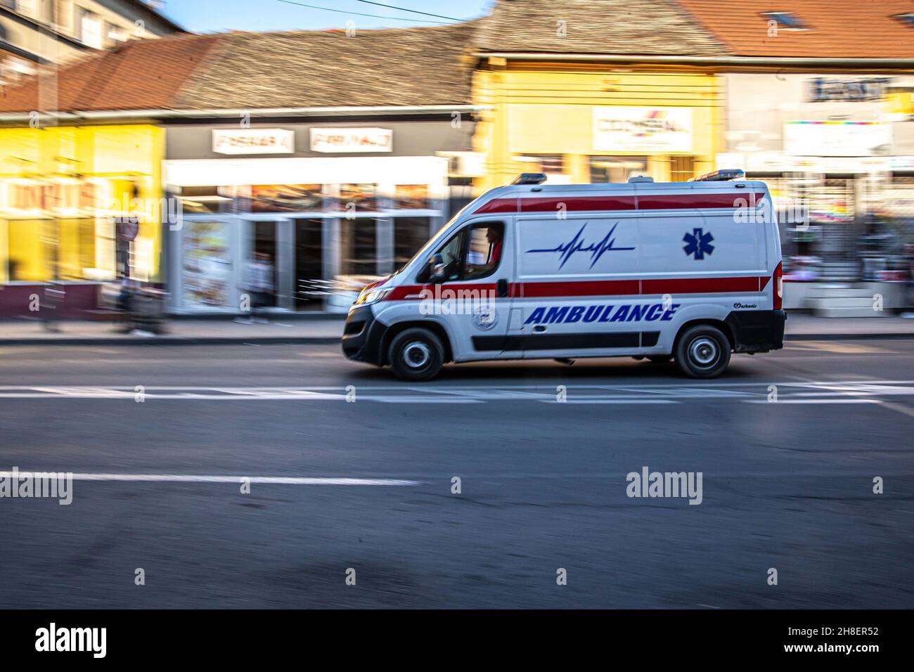 Ambulance rushing through streets Stock Photo - Alamy