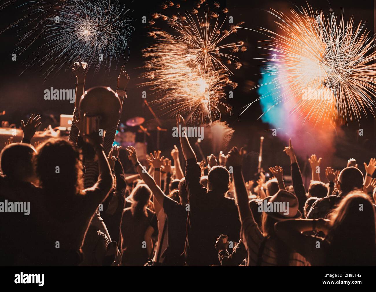 cheering crowd watching fireworks at New Year - holiday celebration ...