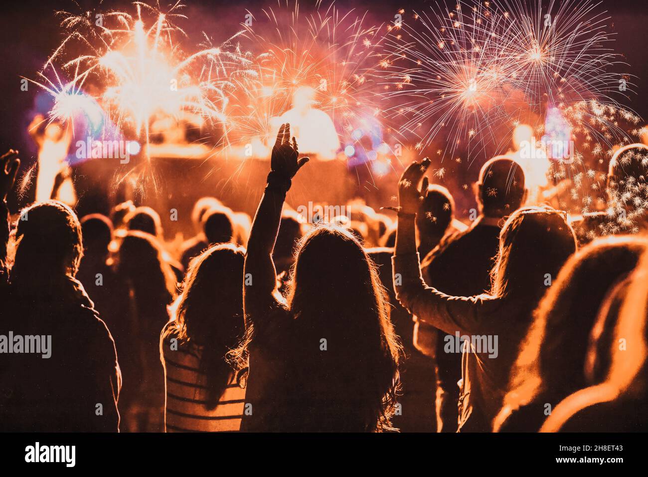 cheering crowd watching fireworks at New Year - holiday celebration ...
