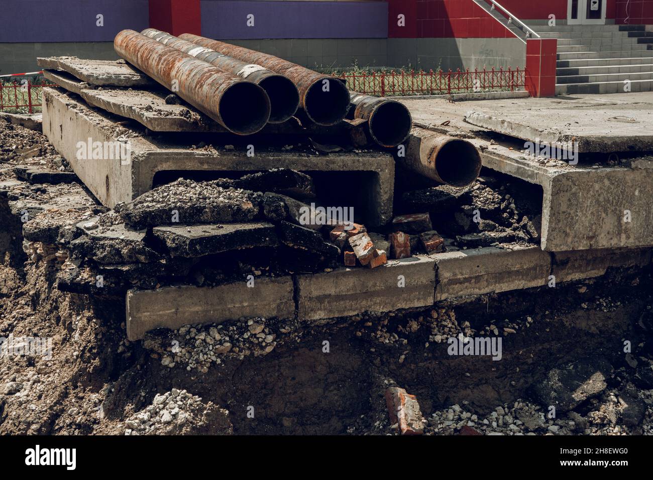 Closeup of rusty large iron pipes in a dug road for repairing Stock ...