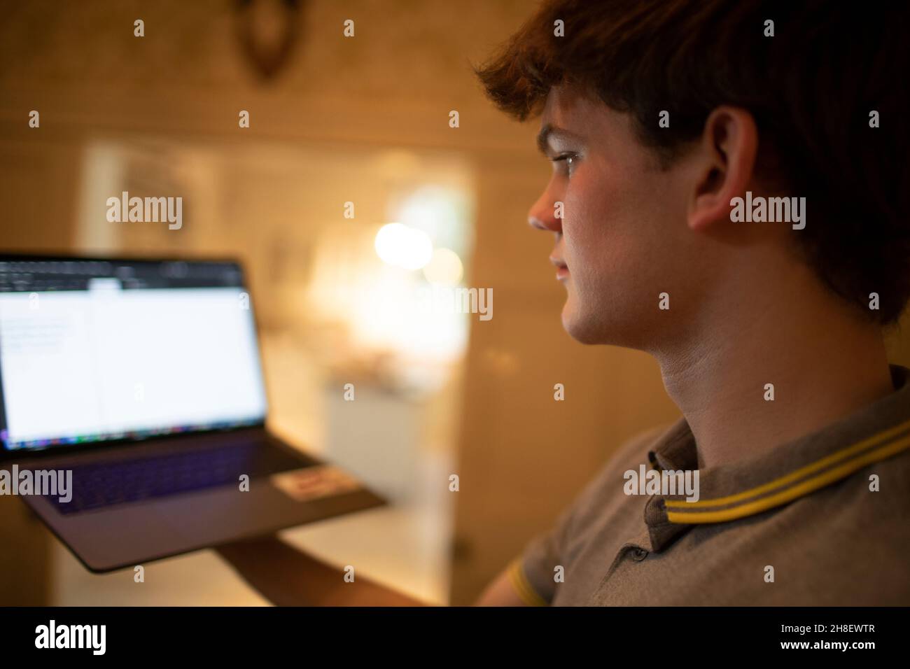 Teen boy on laptop hi-res stock photography and images - Alamy