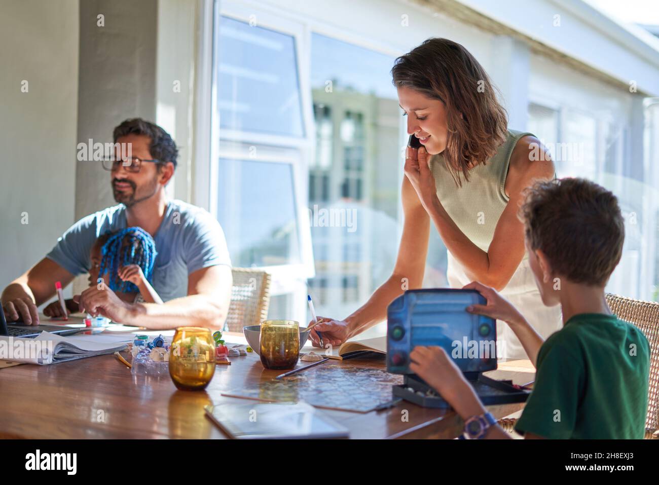 Family working and playing at home Stock Photo - Alamy