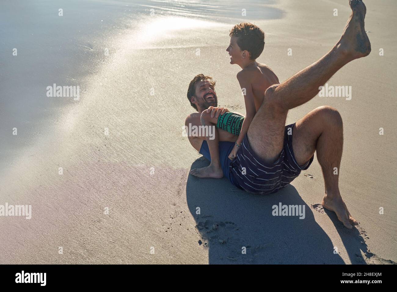 Father son laying on beach hi-res stock photography and images - Alamy