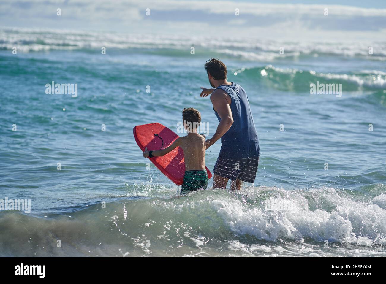 Rear view man body board hi-res stock photography and images - Alamy