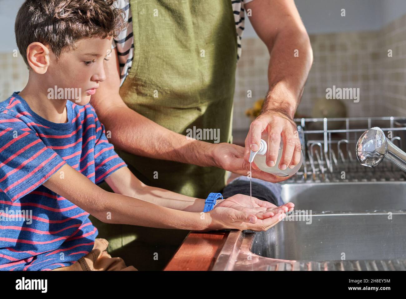 Father and son washing hands with soap at kitchen sink Stock Photo - Alamy