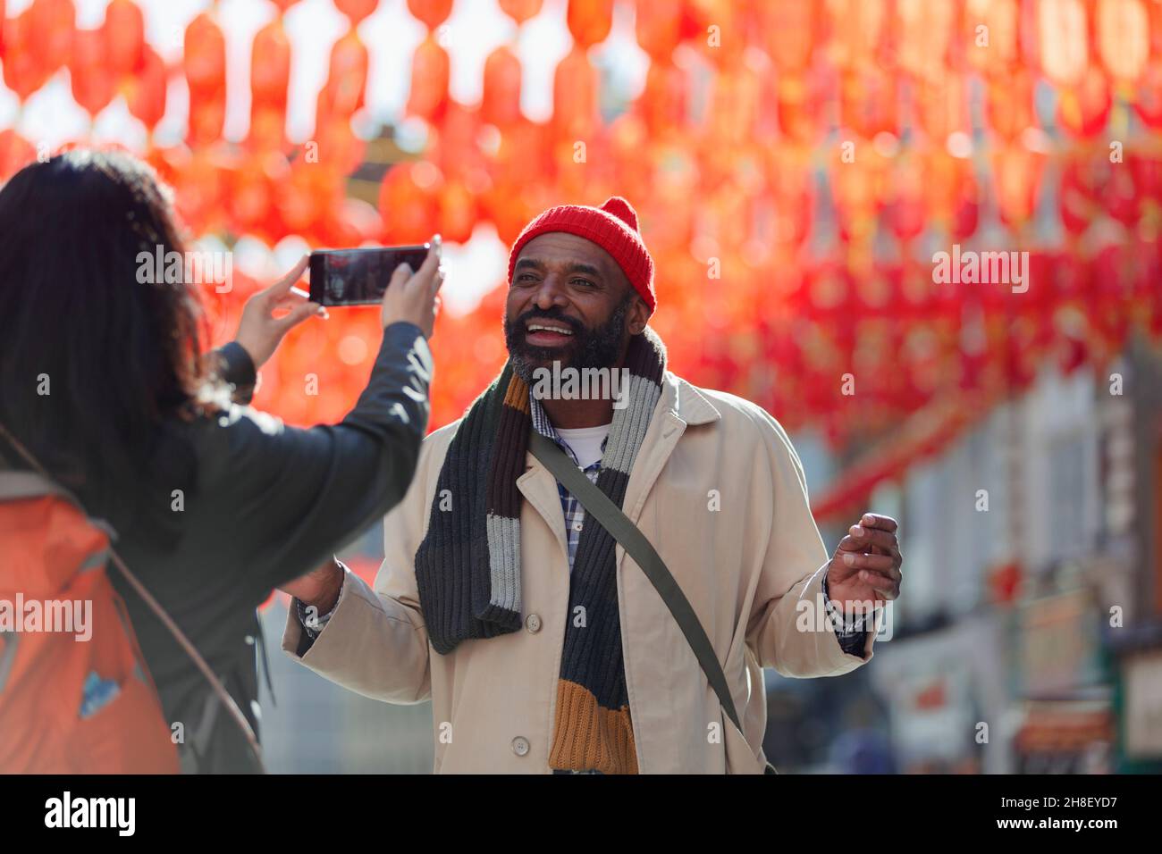 Woman filming vlogger tourist on city street Stock Photo - Alamy
