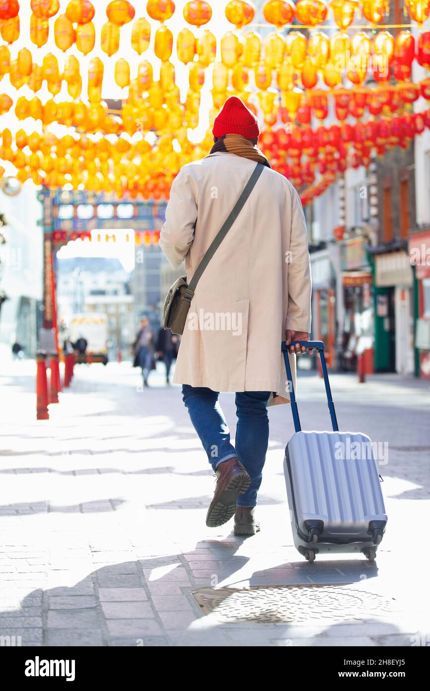 Man pulling suitcase hi-res stock photography and images - Alamy
