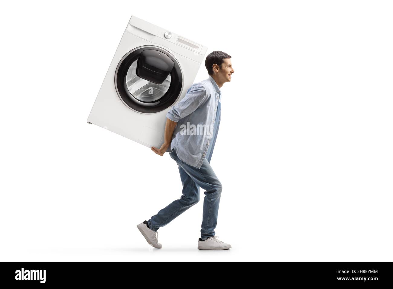 Full length profile shot of a casual young man carrying a washing ...