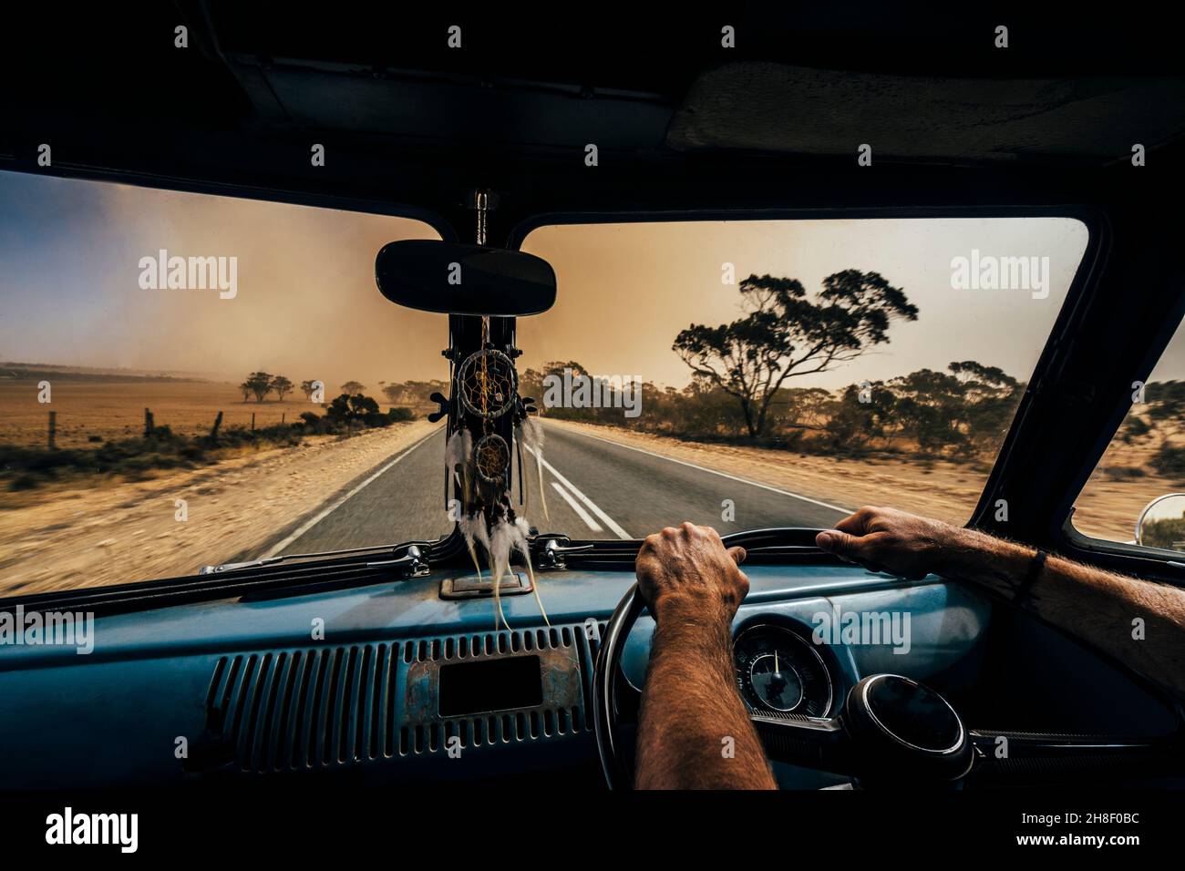 Man driving van on remote desert road, Australian bush Stock Photo - Alamy