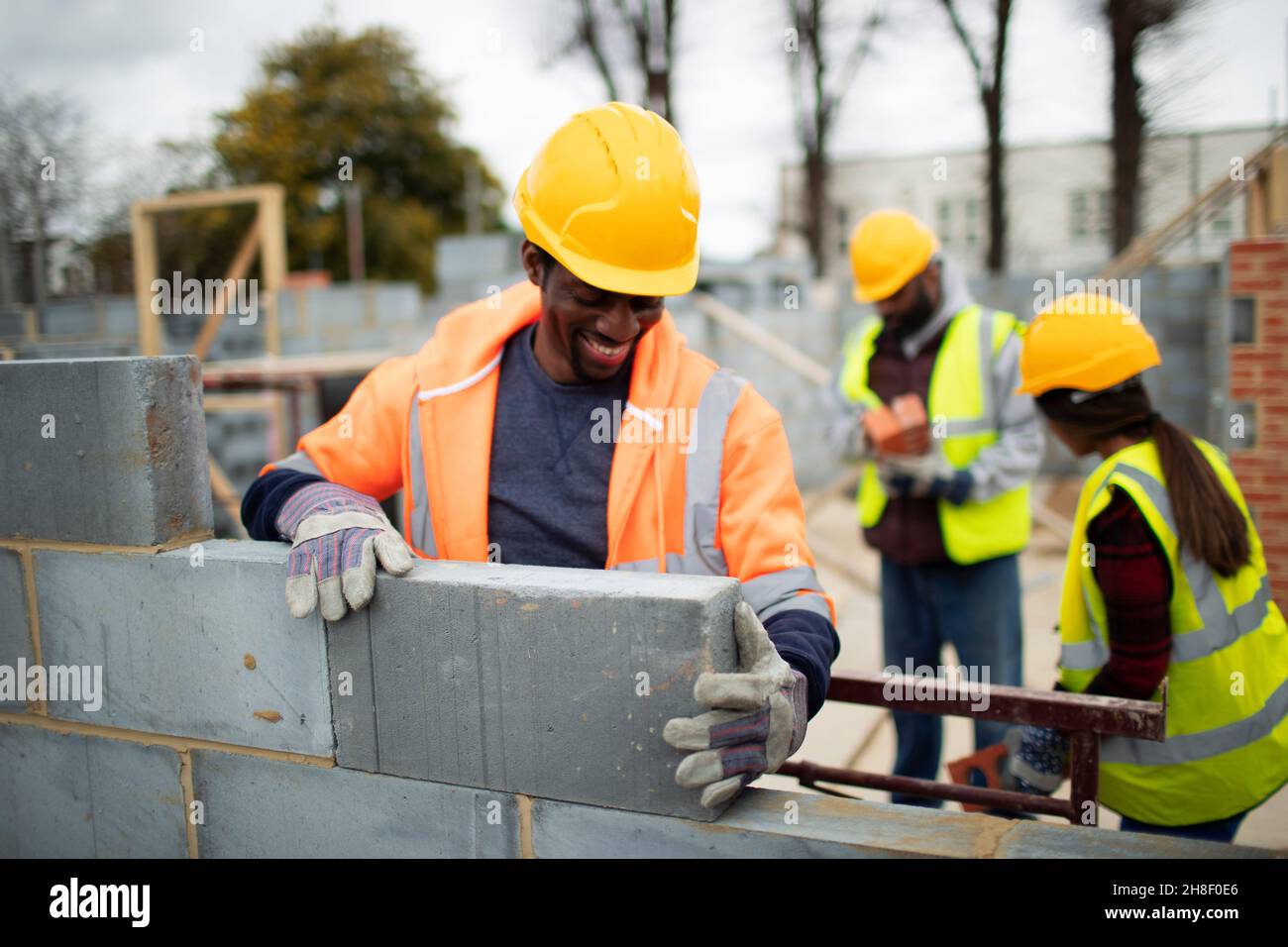Male construction site laying brick at construction site Stock Photo ...