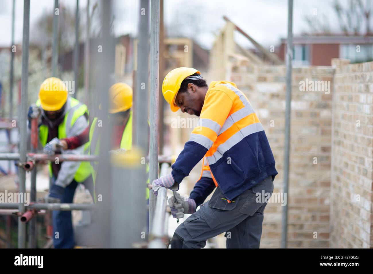 Construction worker assembling scaffolding at construction site Stock ...