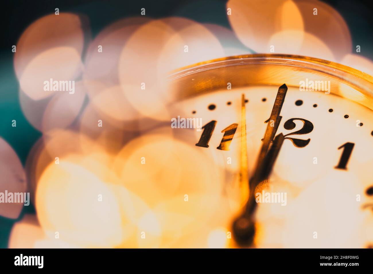 new Year's at midnight - clock at twelve o'clock with holiday lights ...