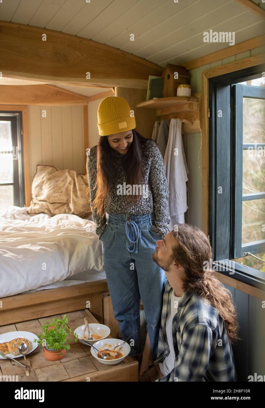Young couple enjoying lunch in tiny cabin rental Stock Photo - Alamy