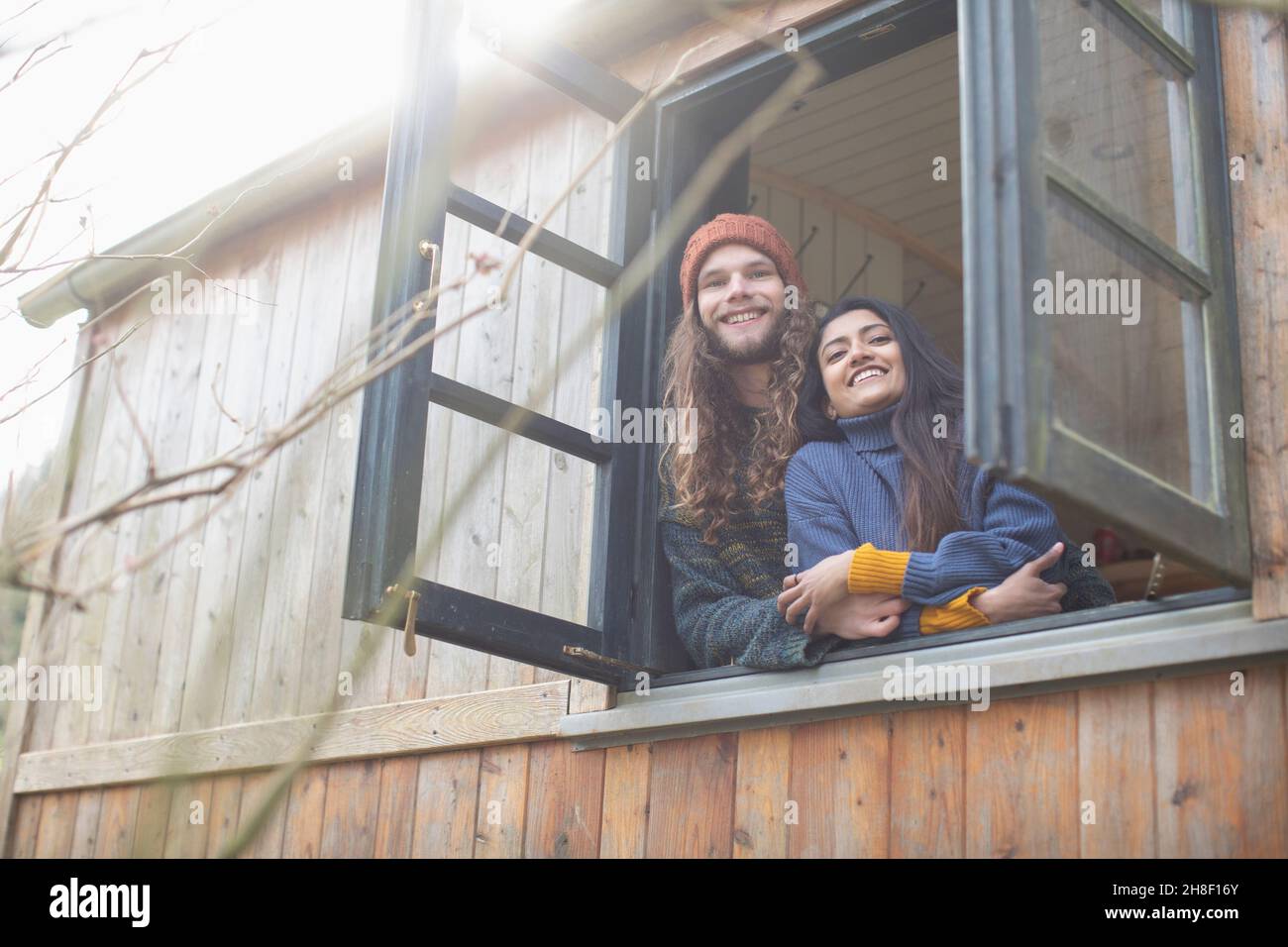 Portrait happy young couple in tiny cabin rental window Stock Photo - Alamy
