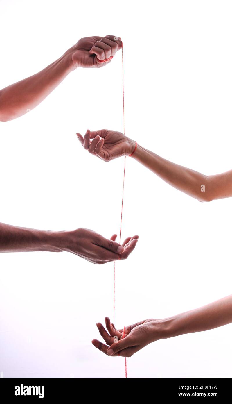 Male and female hands holding a red thread together isolated on white ...
