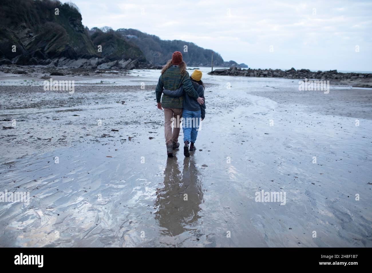 Woman walking on wet ocean sand beach hi-res stock photography and ...