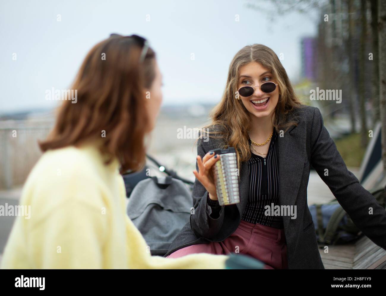 Young women friends talking Stock Photo - Alamy