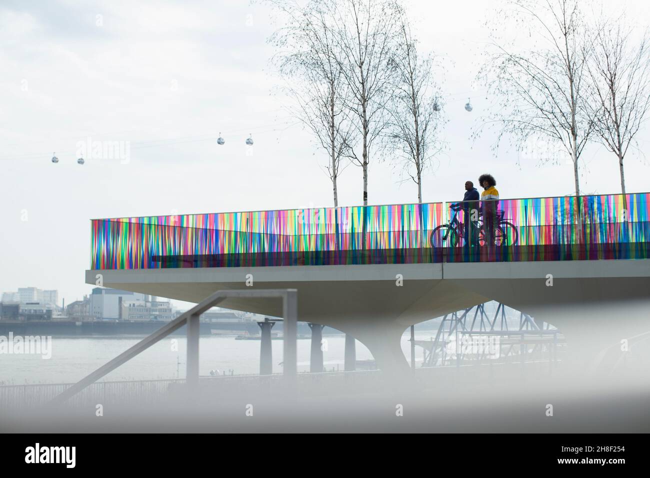 Father and son on bicycles on urban footbridge, London, UK Stock Photo ...