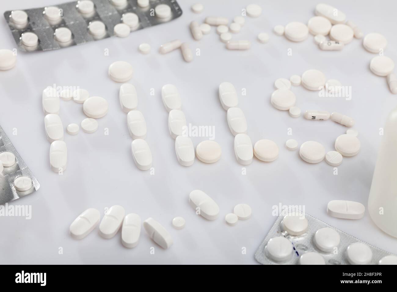Tablets formed word PILLS Stock Photo - Alamy