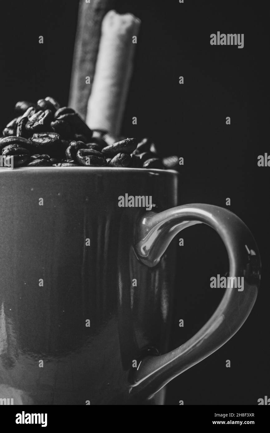 Grayscale shot of coffee beans in a mug Stock Photo - Alamy