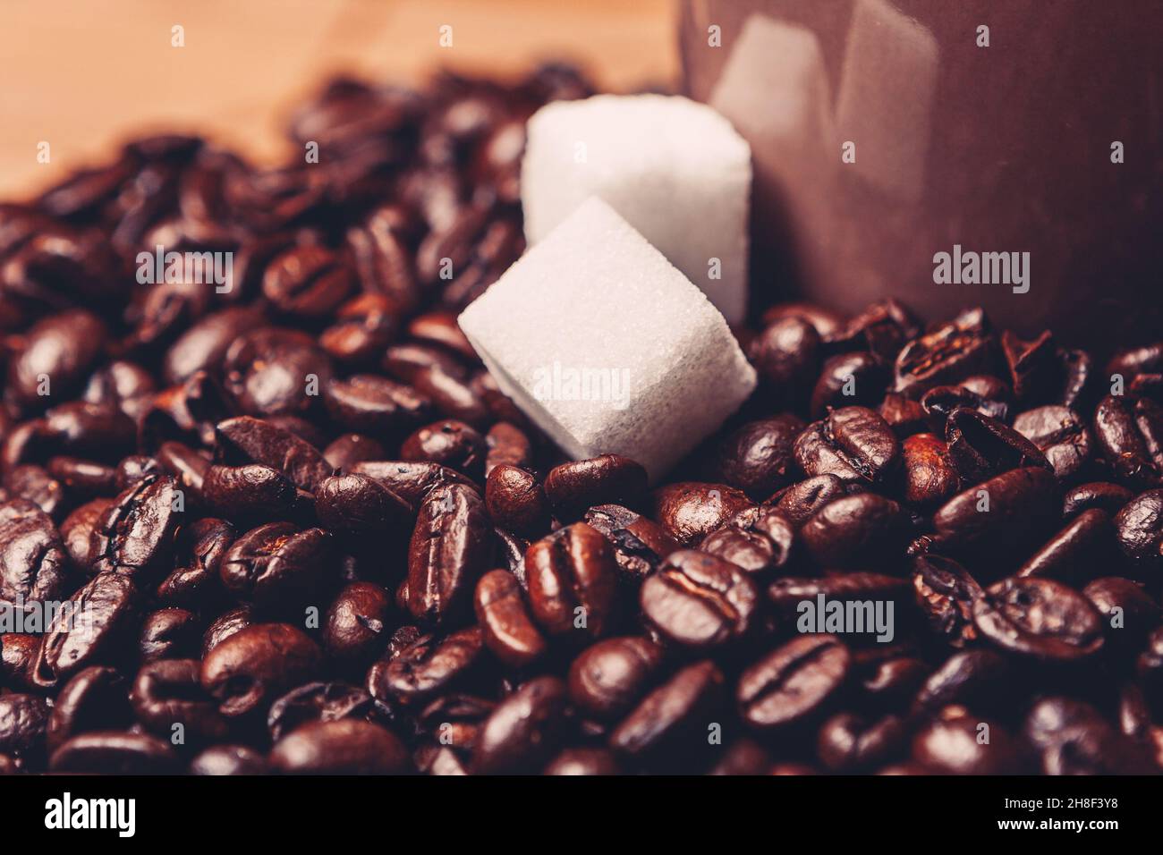 Coffee beans and sugar cubes near the mug Stock Photo - Alamy