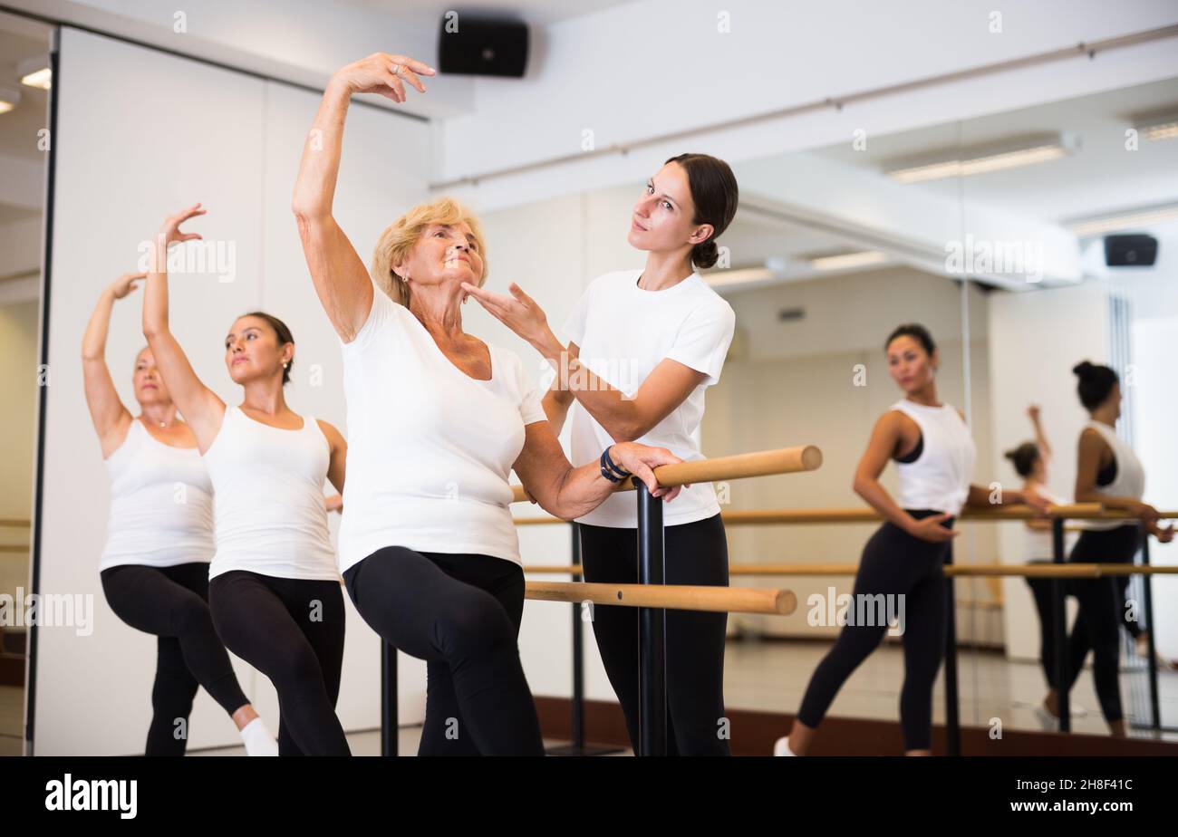 Female choreographer and group of multiracial dancers in dance school ...