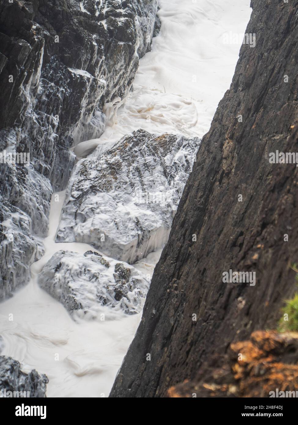 Force of nature. Creamy white foam, froth from sea water crashing and ...