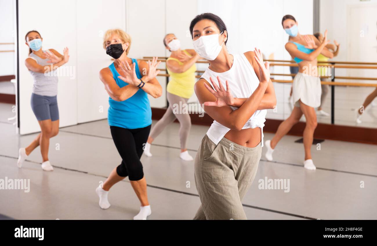 Women in masks dancing together in studio Stock Photo - Alamy