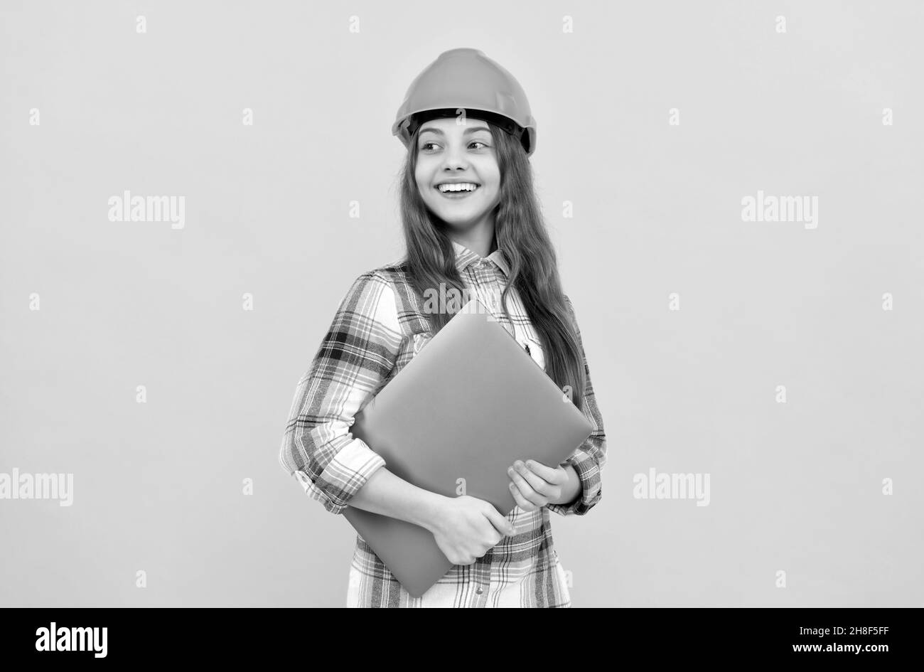 teen girl in helmet use laptop. builder kid hold computer. building and ...