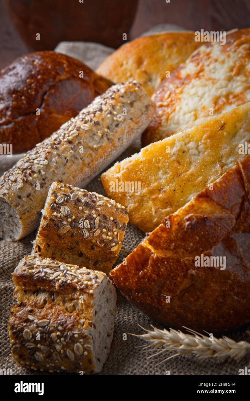 A close up still life photo of various loafs of natural whole bread ...