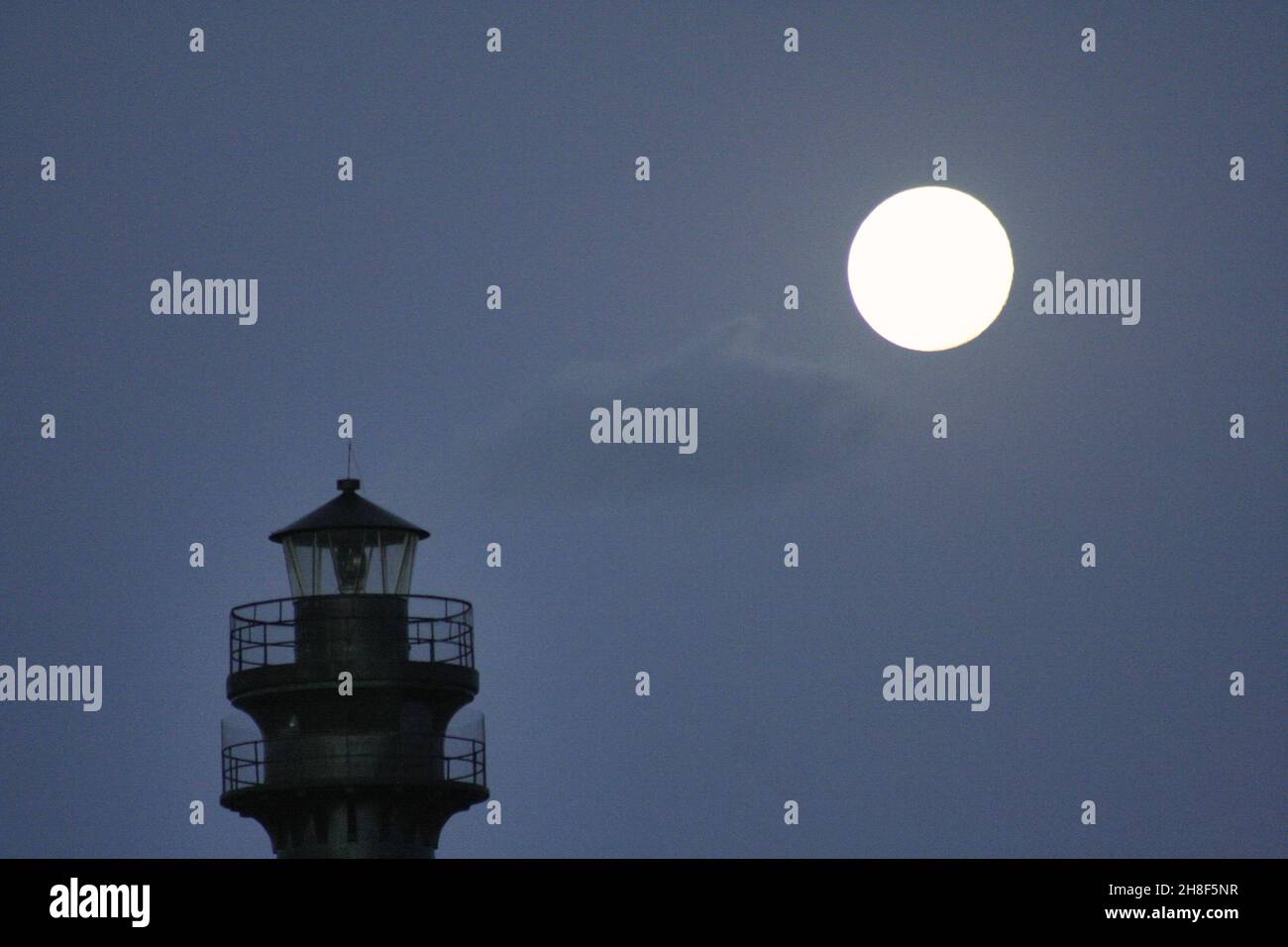 Top of a lighthouse and the full moon at night Stock Photo - Alamy