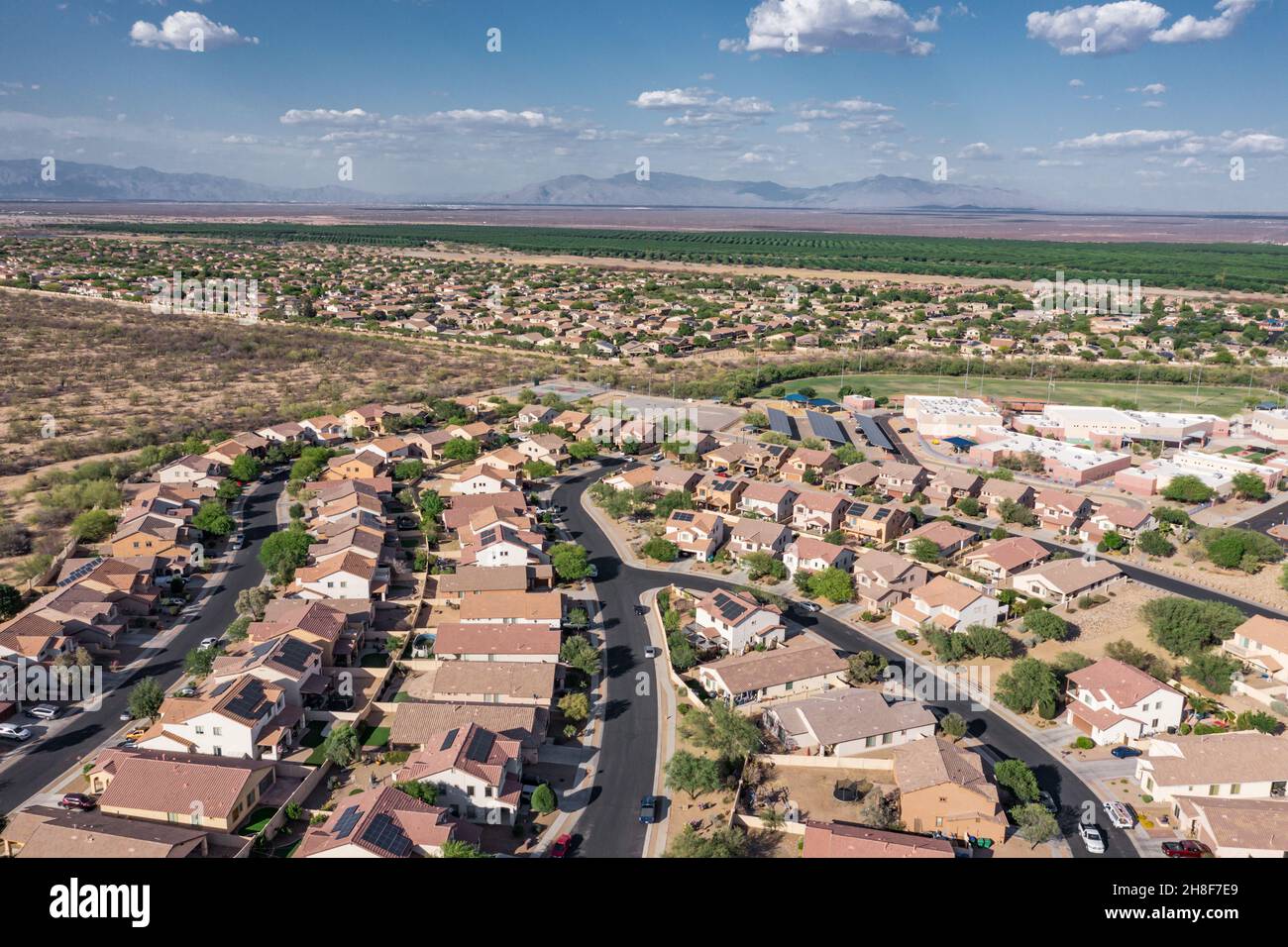 Residential complex with new houses and mountains in background ...